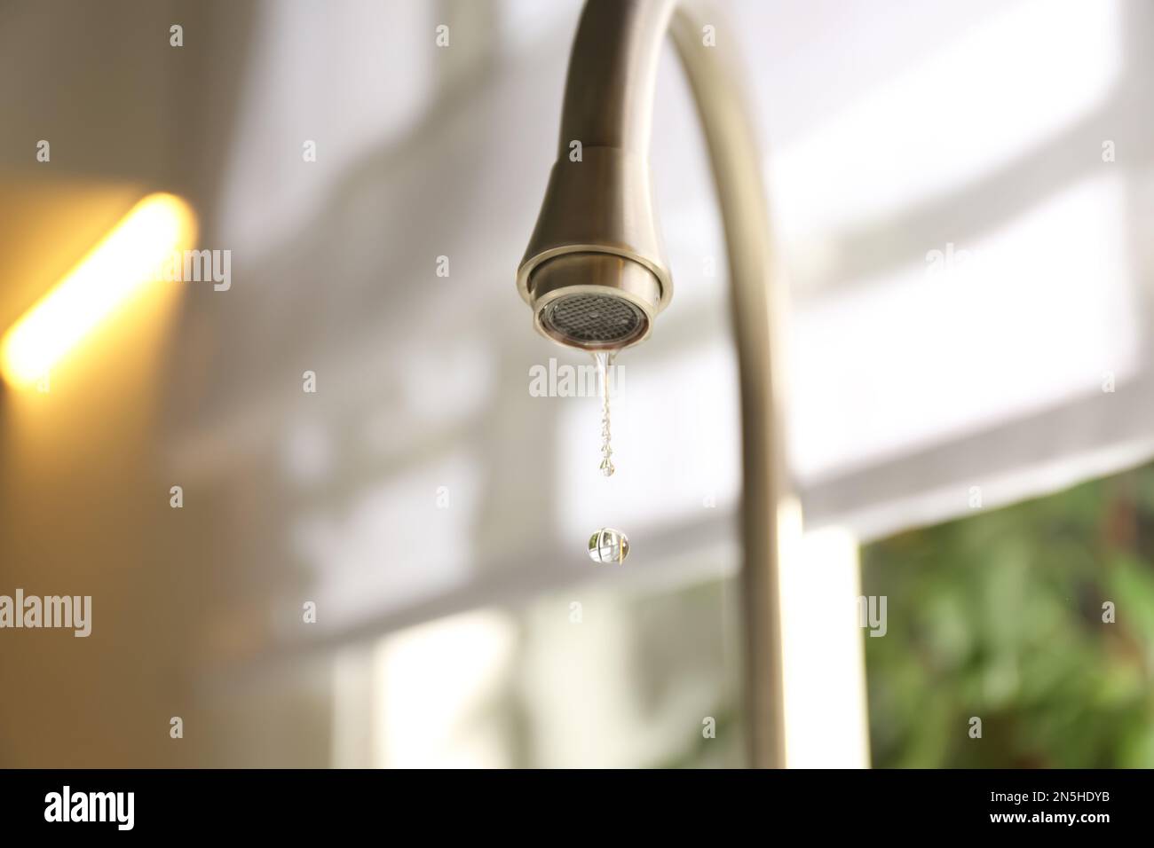 Water drops falling down from tap on blurred background, closeup Stock ...