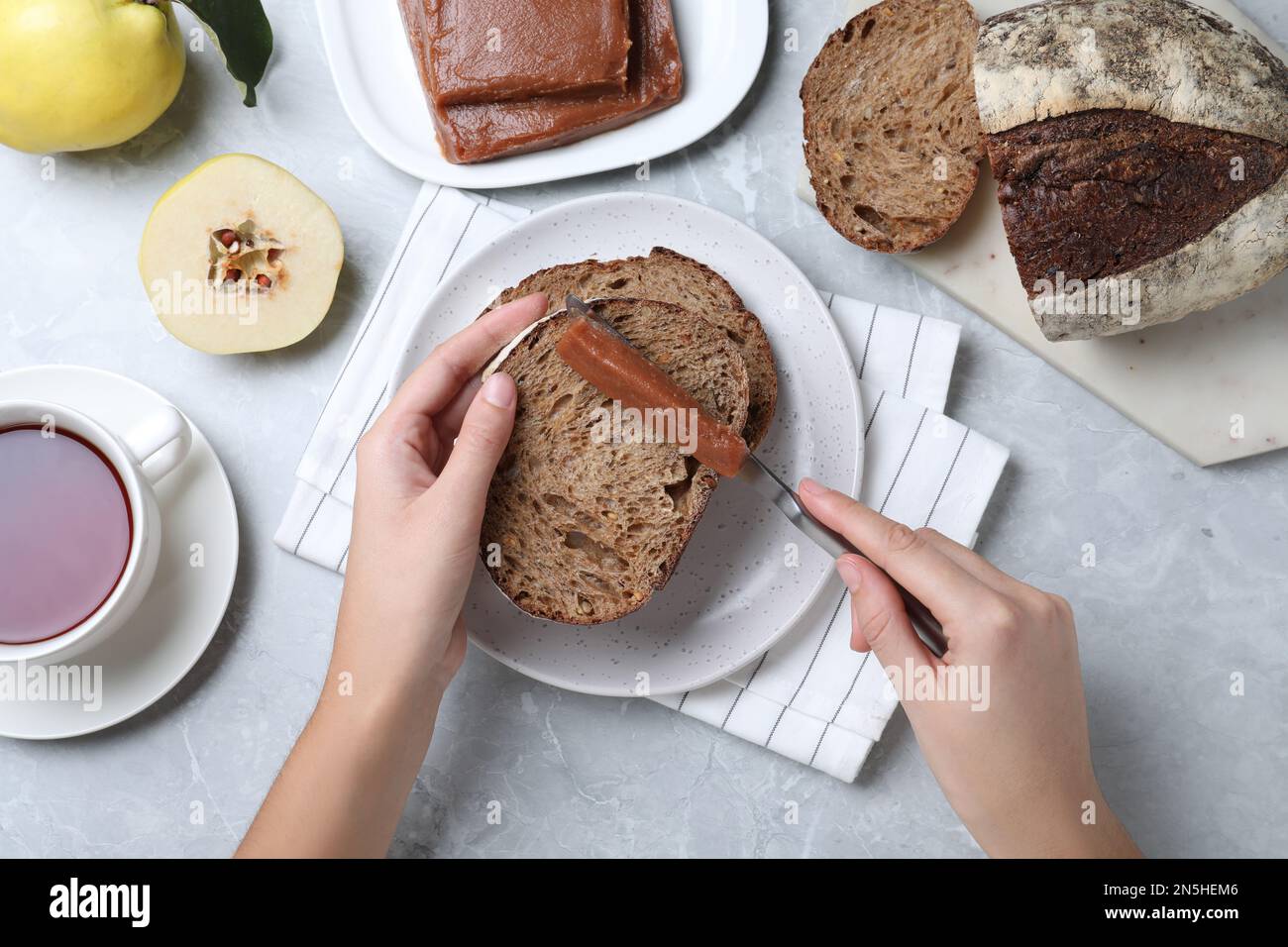 Woman making sandwich with quince paste at table, top view Stock Photo ...