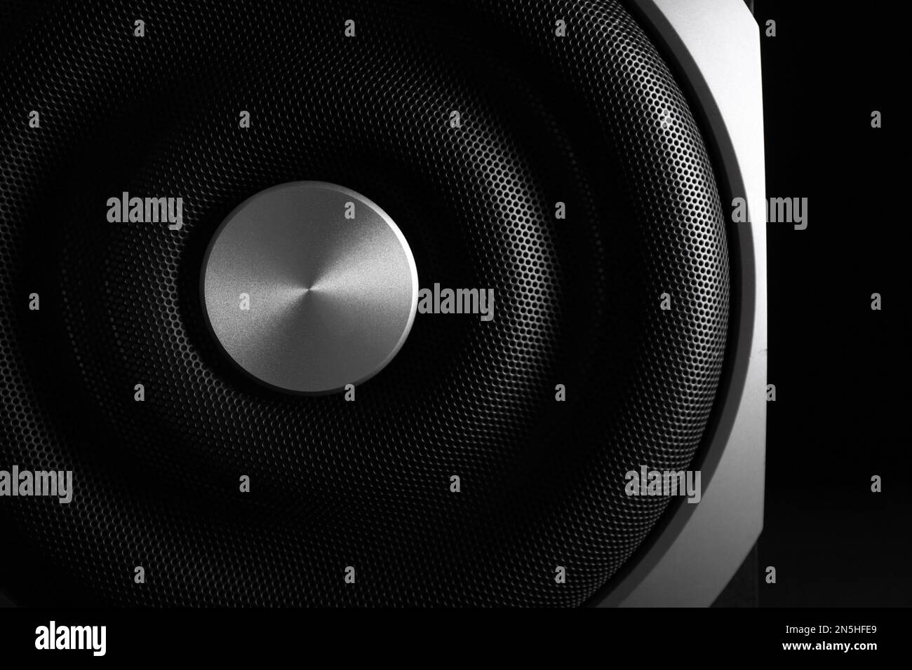Modern subwoofer on black background, closeup. Powerful audio speaker ...