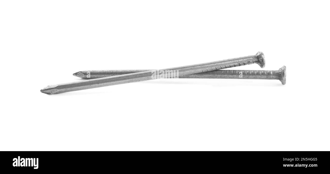 Sharp shiny metal nails on white background Stock Photo - Alamy