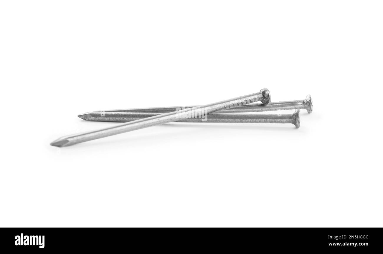 Sharp shiny metal nails on white background Stock Photo - Alamy