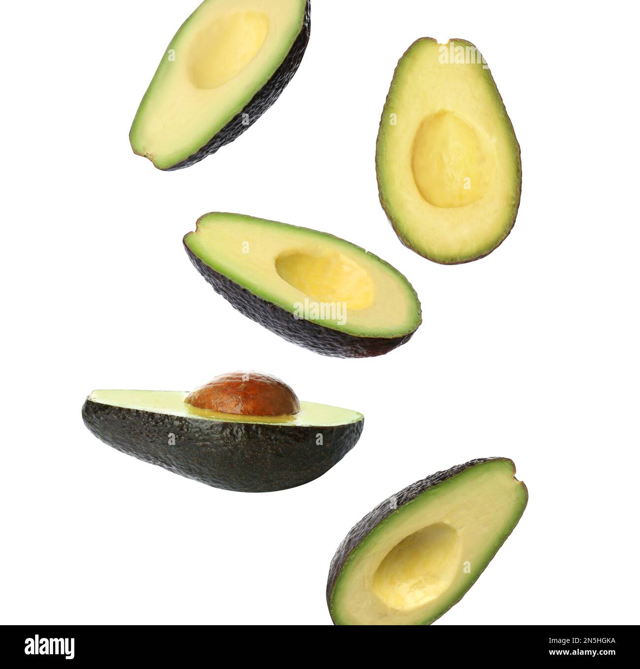 Falling fresh ripe avocados on white background Stock Photo - Alamy