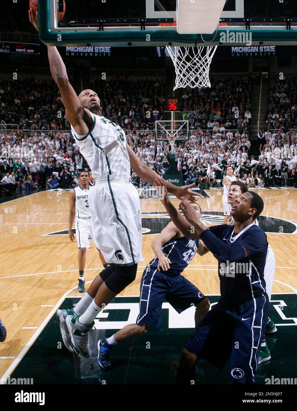 Michigan State's Adreian Payne, left, shoots over Penn State's Jordan ...