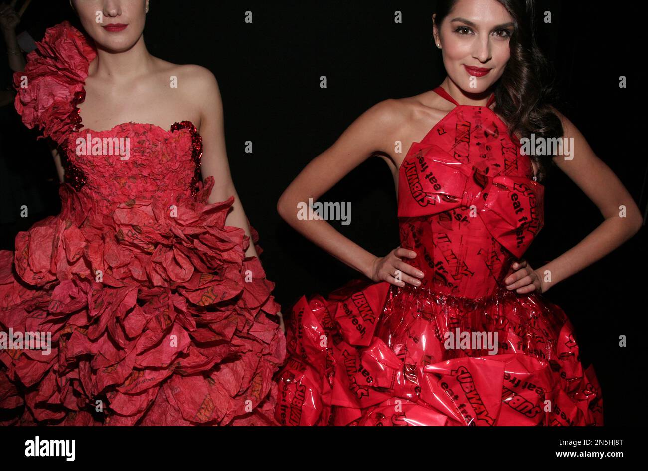 Models wear dresses made from Subway sandwich wrappers at the MBFW 2014 ...