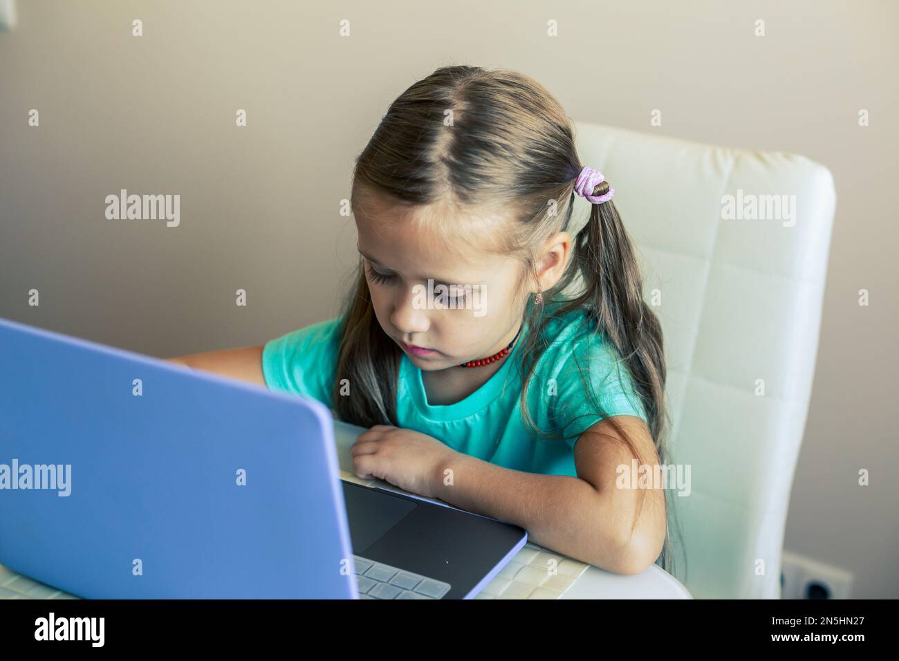 Little cute girl uses laptop to have video call Stock Photo - Alamy