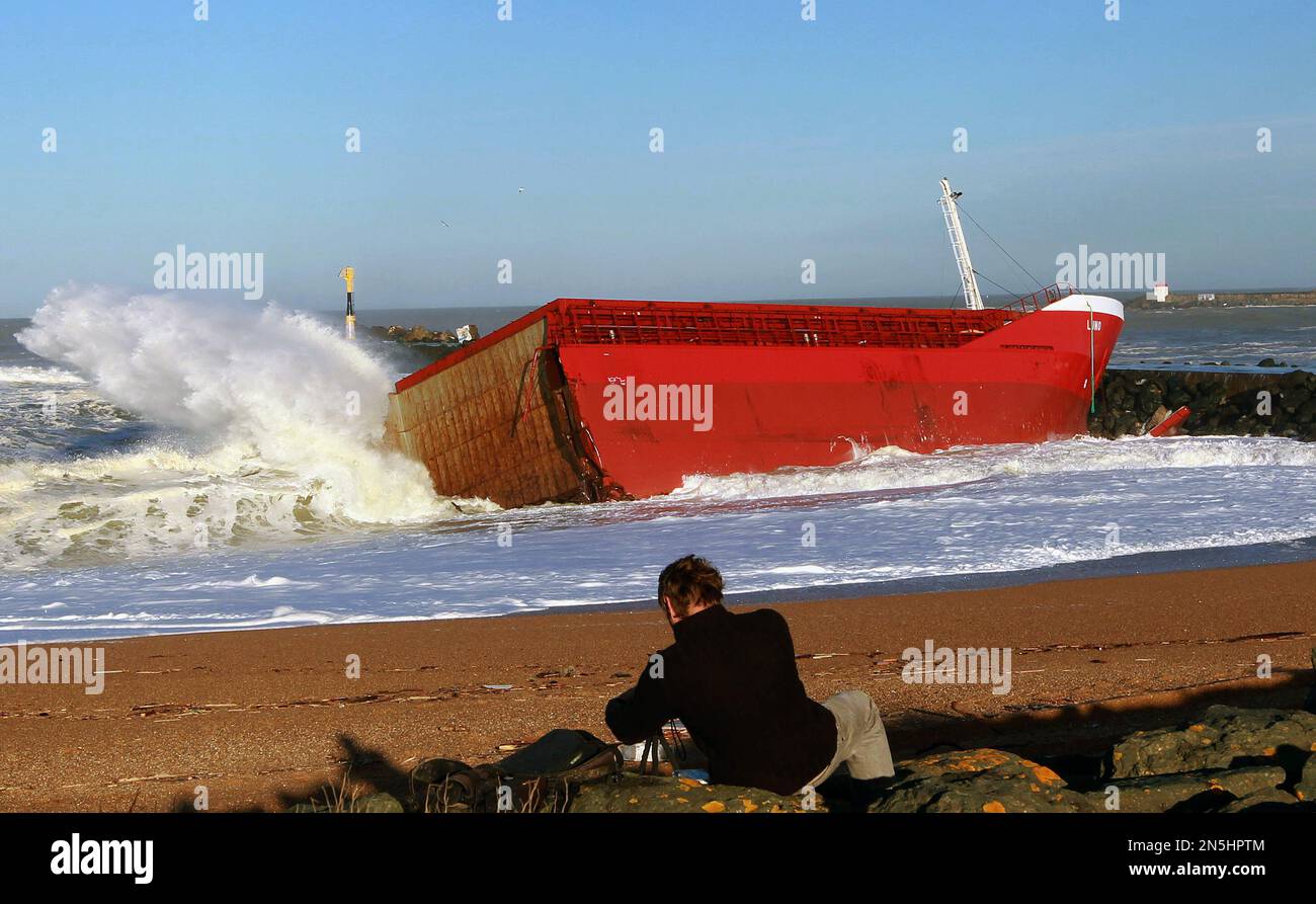 A man takes picture of the wreck of the Spanish cargo ship "Luno" that ...