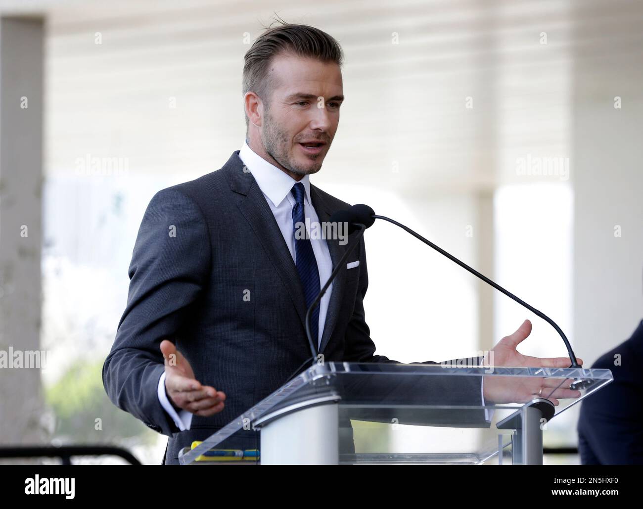 Former English soccer star David Beckham speaks at a news conference ...