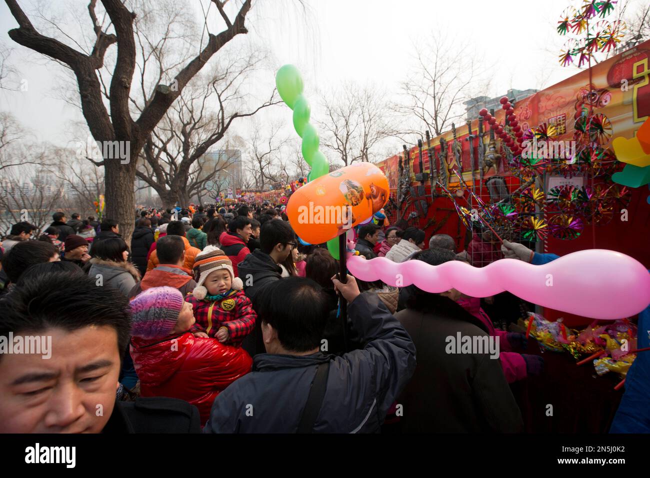 Residents visit a spring festival temple fair held at the Dragon Lake ...