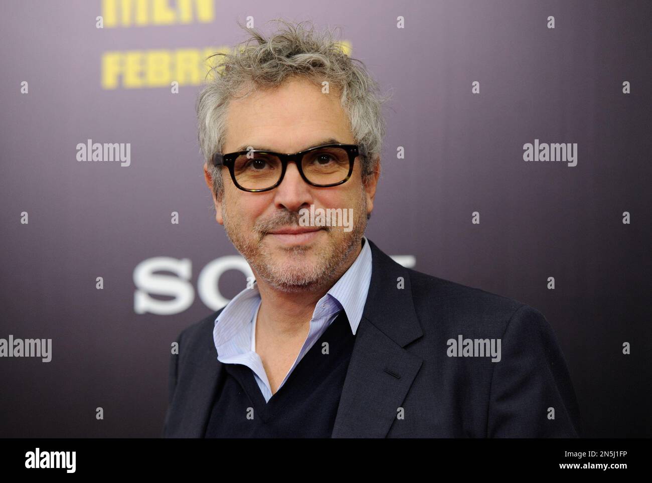 Director Alfonso Cuarón attends the premiere of "The Monuments Men" at ...