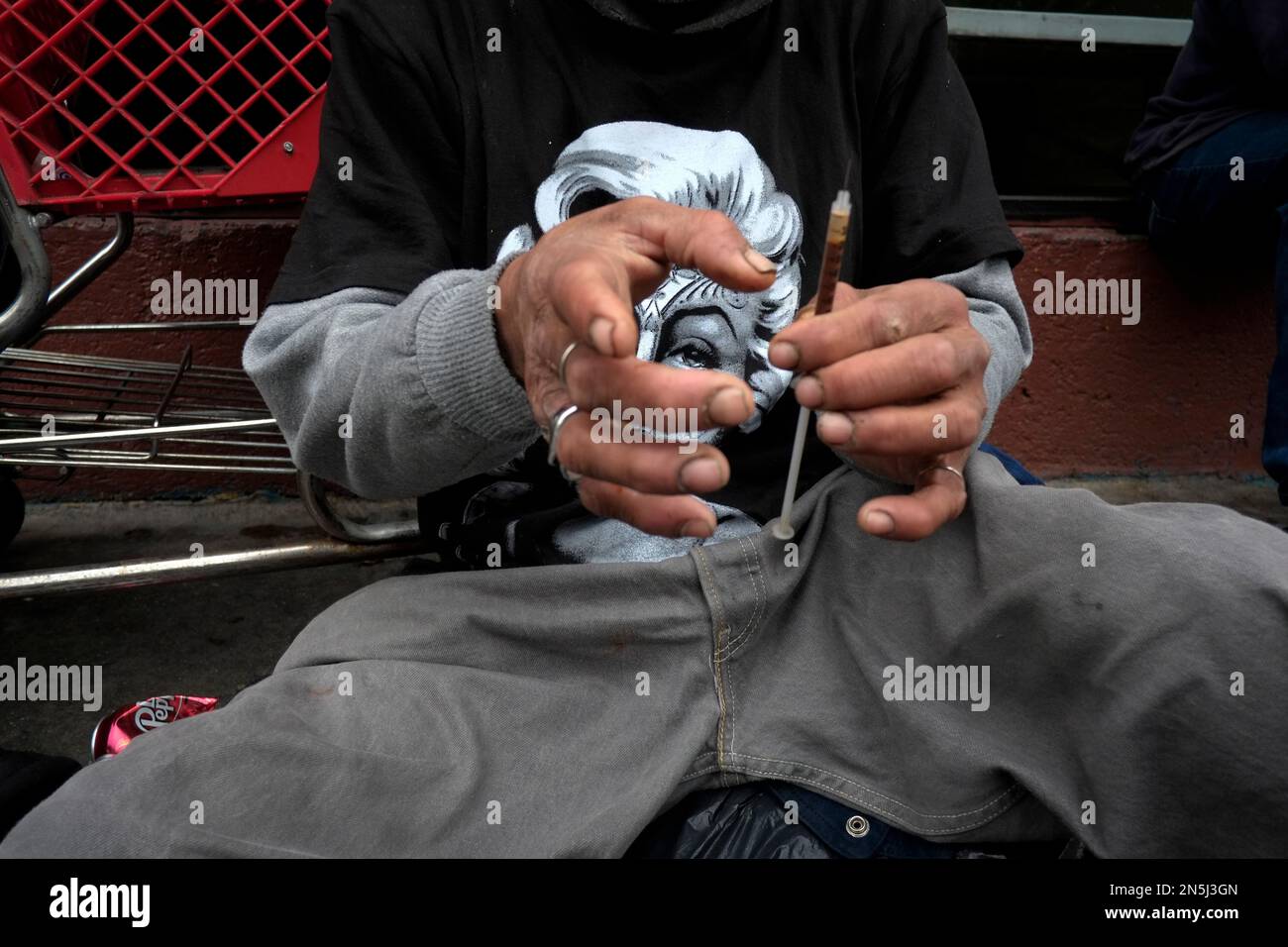 FILE - In this Monday, May 6, 2013 file photo, a drug addict prepares a ...