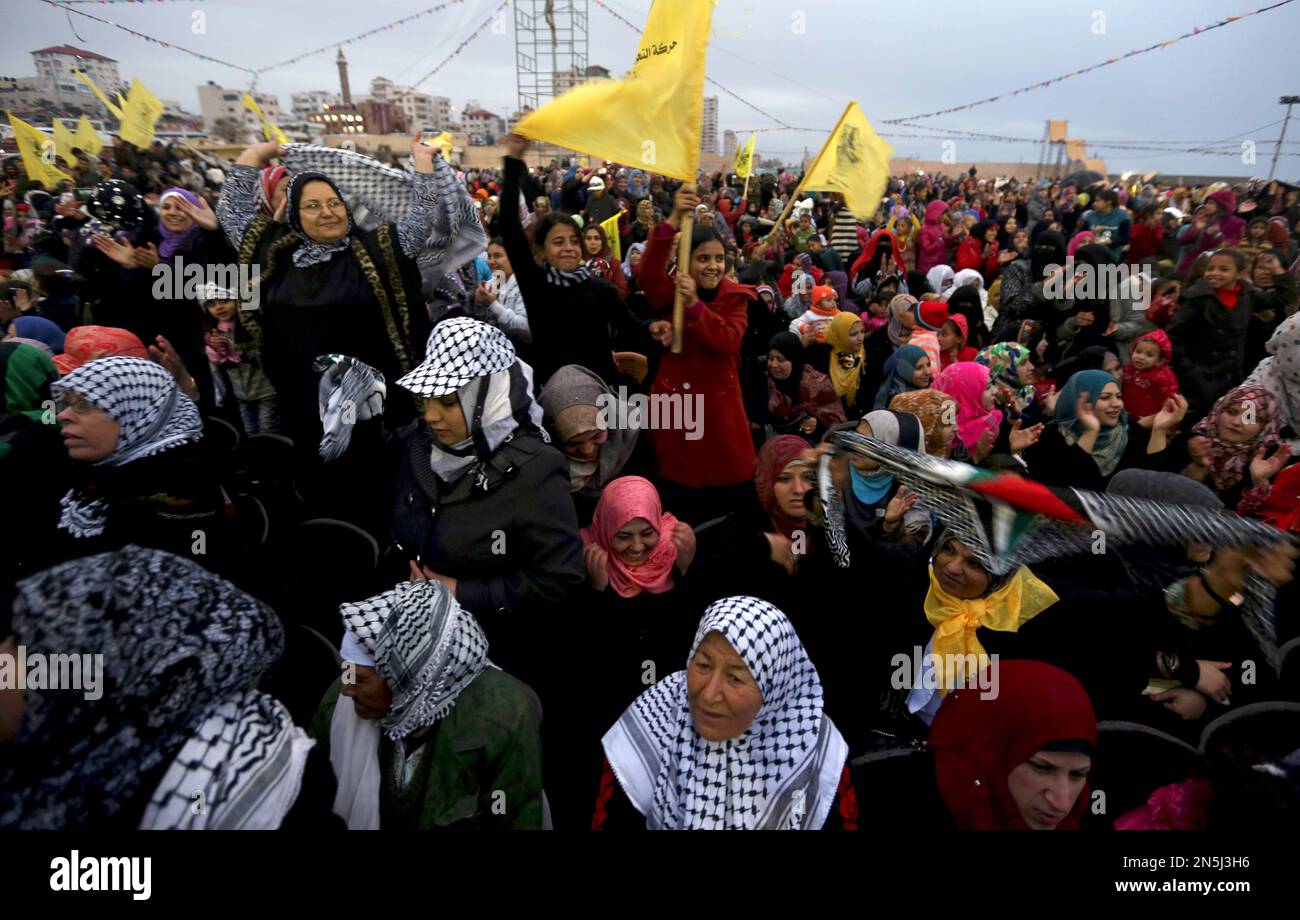Palestinians celebrate at a mass wedding ceremony on the beach of Gaza ...