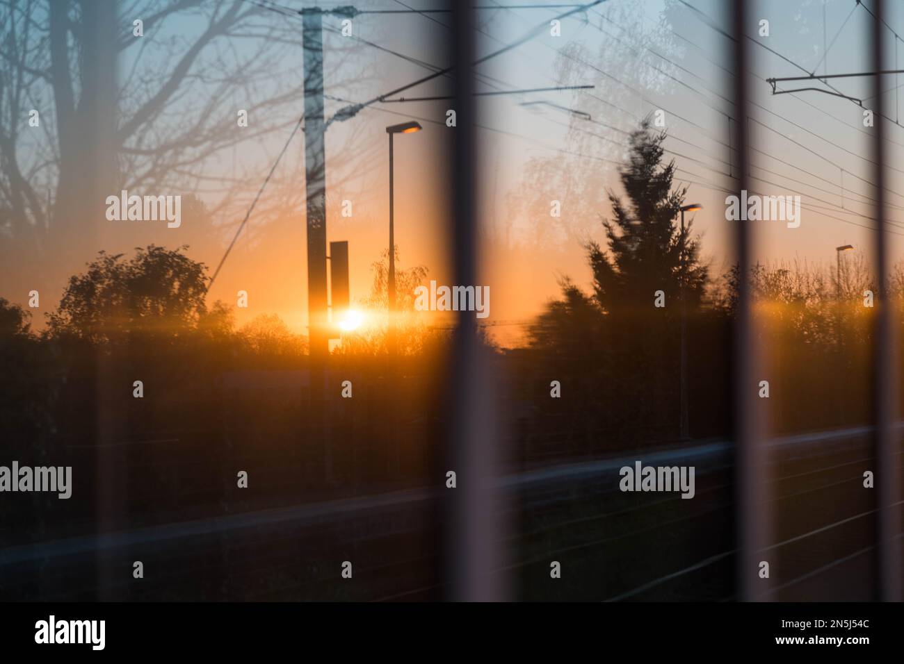 The bright sunset visible through the glass window Stock Photo - Alamy