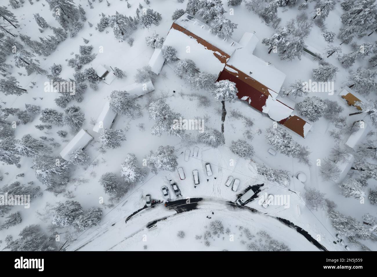 Drone scenery of car vehicles covered in snow on parked on a frozen ...