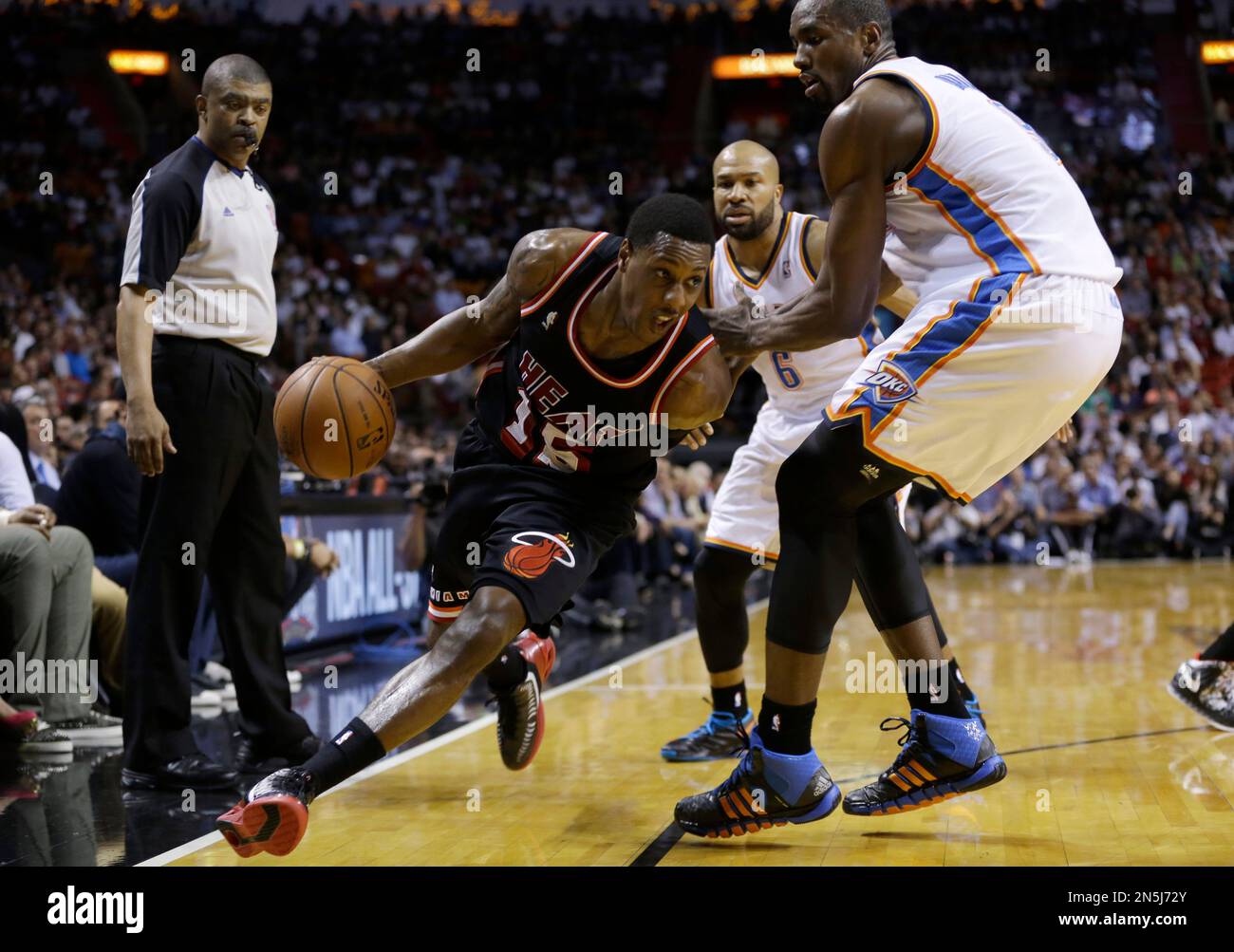 Miami Heat point guard Mario Chalmers (15) drives around Oklahoma City ...