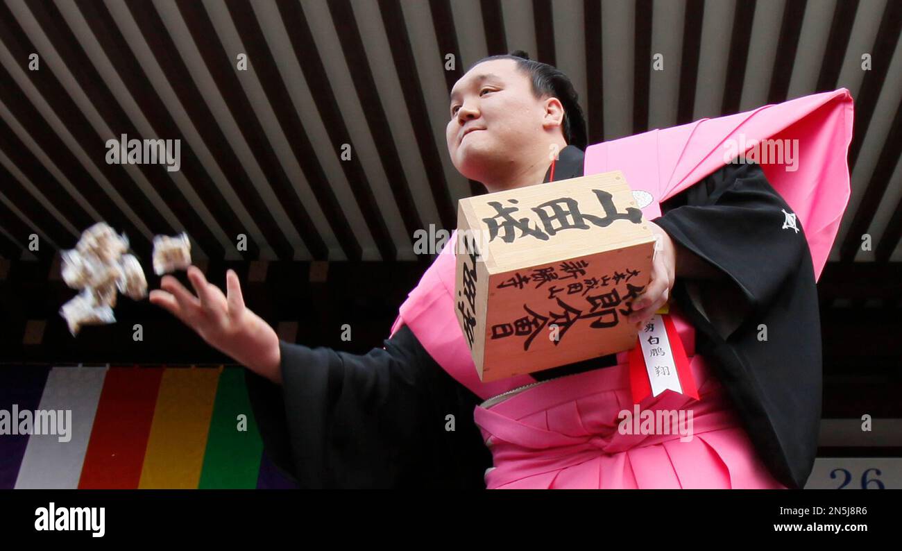 Mongolian sumo grand champion Hakuho throws bags of beans during the ...