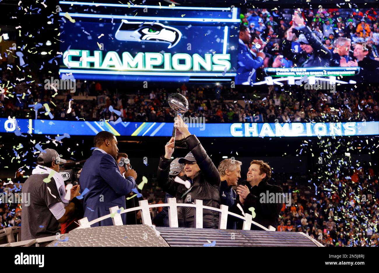 Seattle Seahawks owner Paul Allen raises the Vince Lombardi Trophy ...