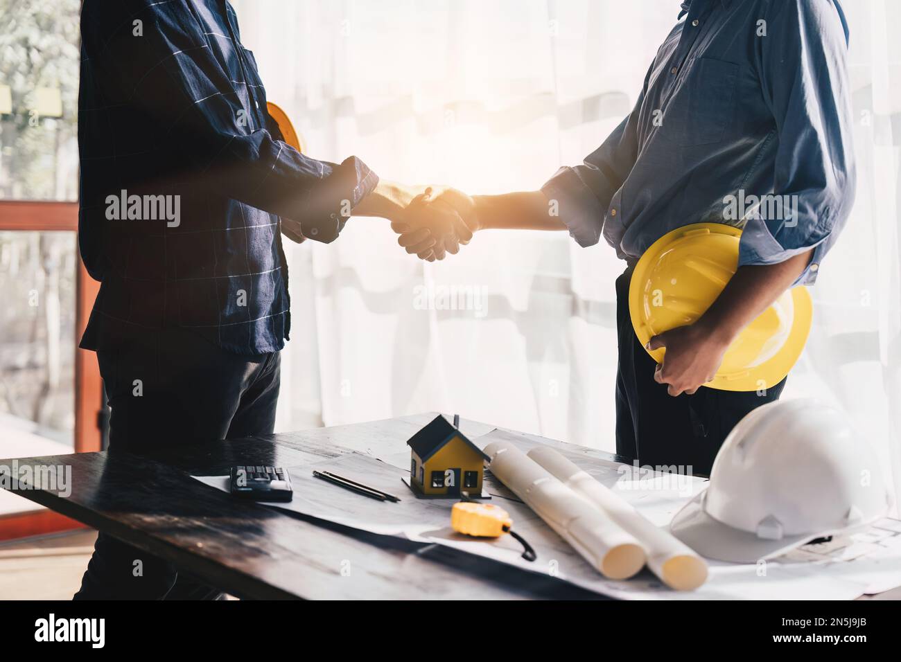 Architecture or Civil engineer analyze handshake making modern ...