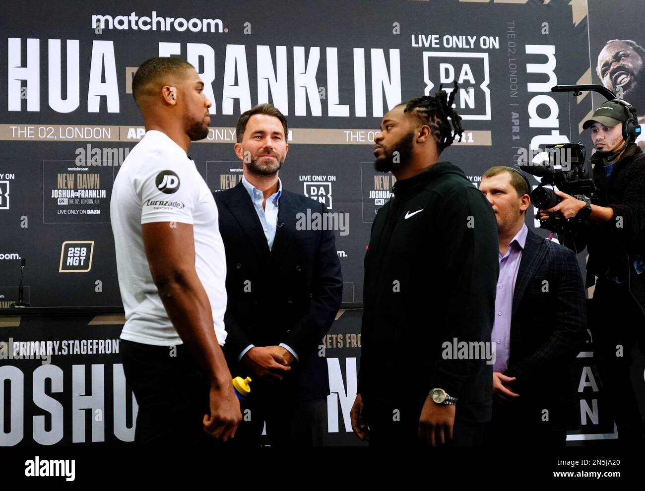 Promoter Eddie Hearn stands in the centre as Anthony Joshua (left) and ...