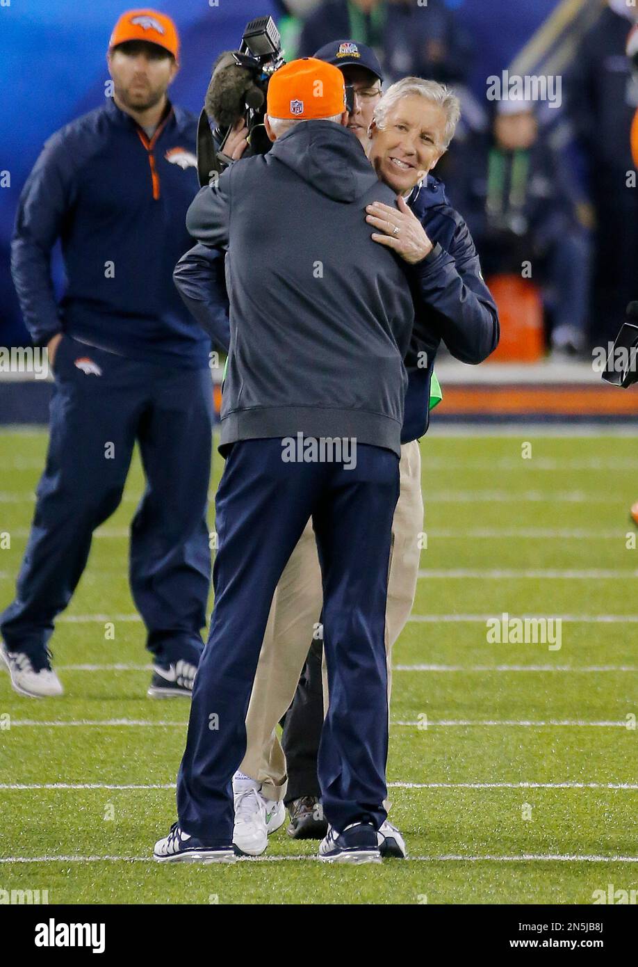 Seattle Seahawks head coach Pete Carroll, facing, hugs Denver Broncos ...