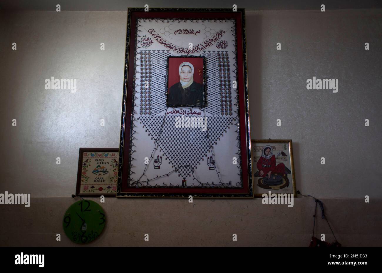 In this photo taken Saturday, Feb. 1, 2014, a photo of late Ayat al ...