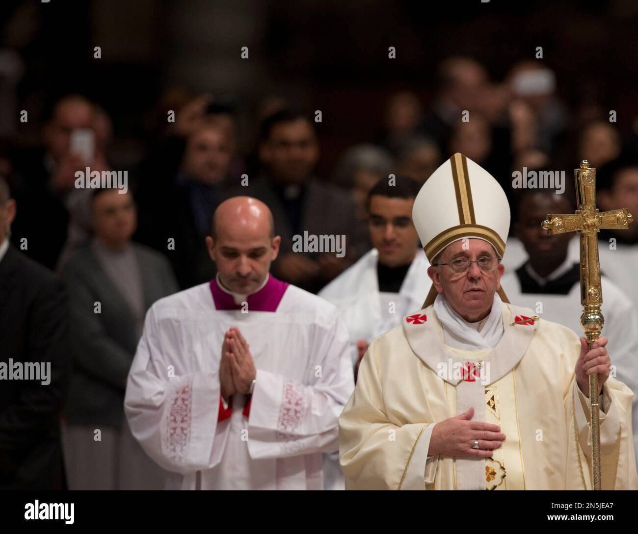 Pope Francis holds the pastoral staff as he leaves after celebrating a ...