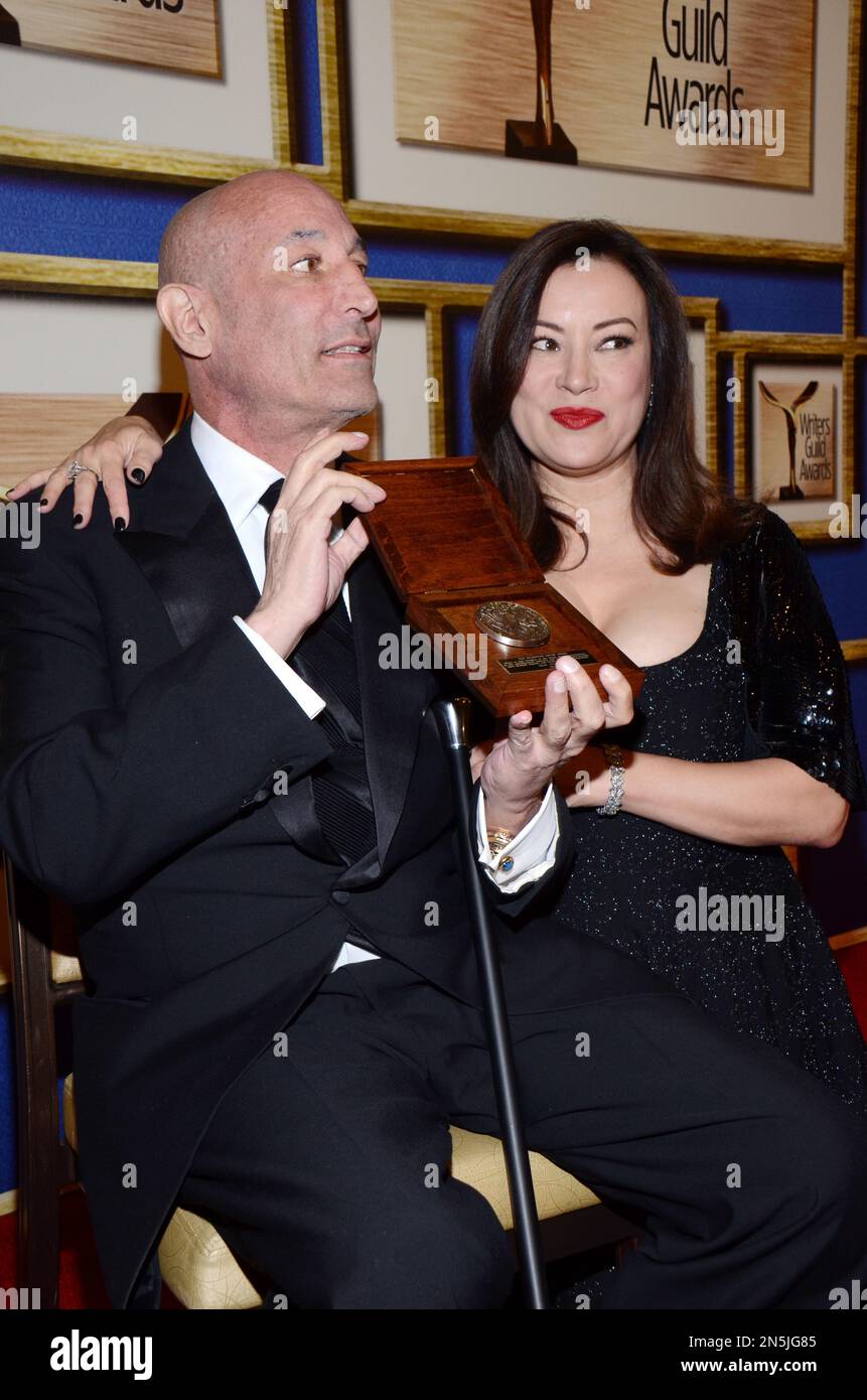 Sam Simon, left, poses in the press room with Jennifer Tilly with his ...