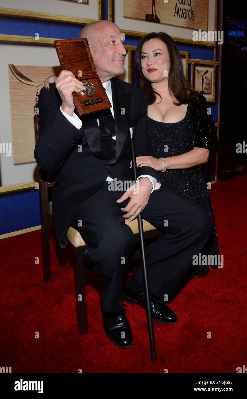 Sam Simon, left, poses in the press room with Jennifer Tilly with his ...