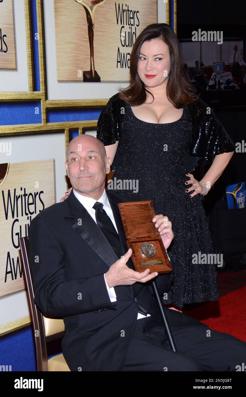 Sam Simon, left, poses in the press room with Jennifer Tilly with his ...