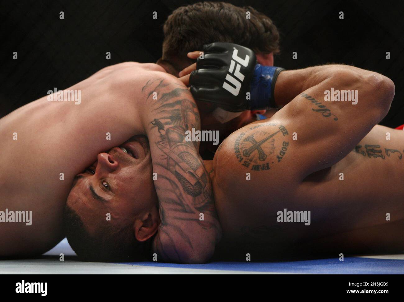 Jamie Varner, top, and Abel Trujillo fight during the first round of a ...