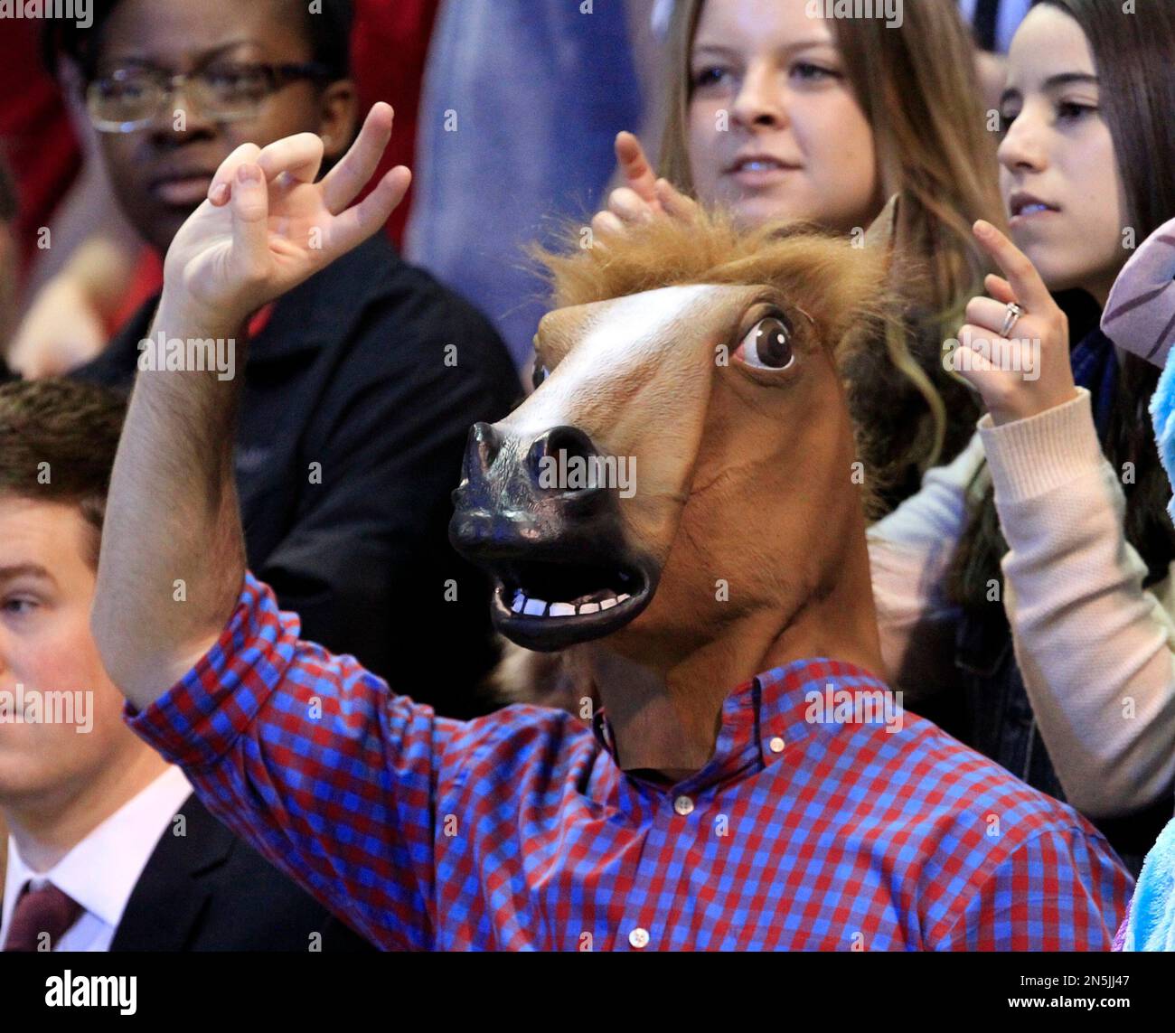 An SMU fan wearing a Pony head signals his "pony Ears" hand sign before ...