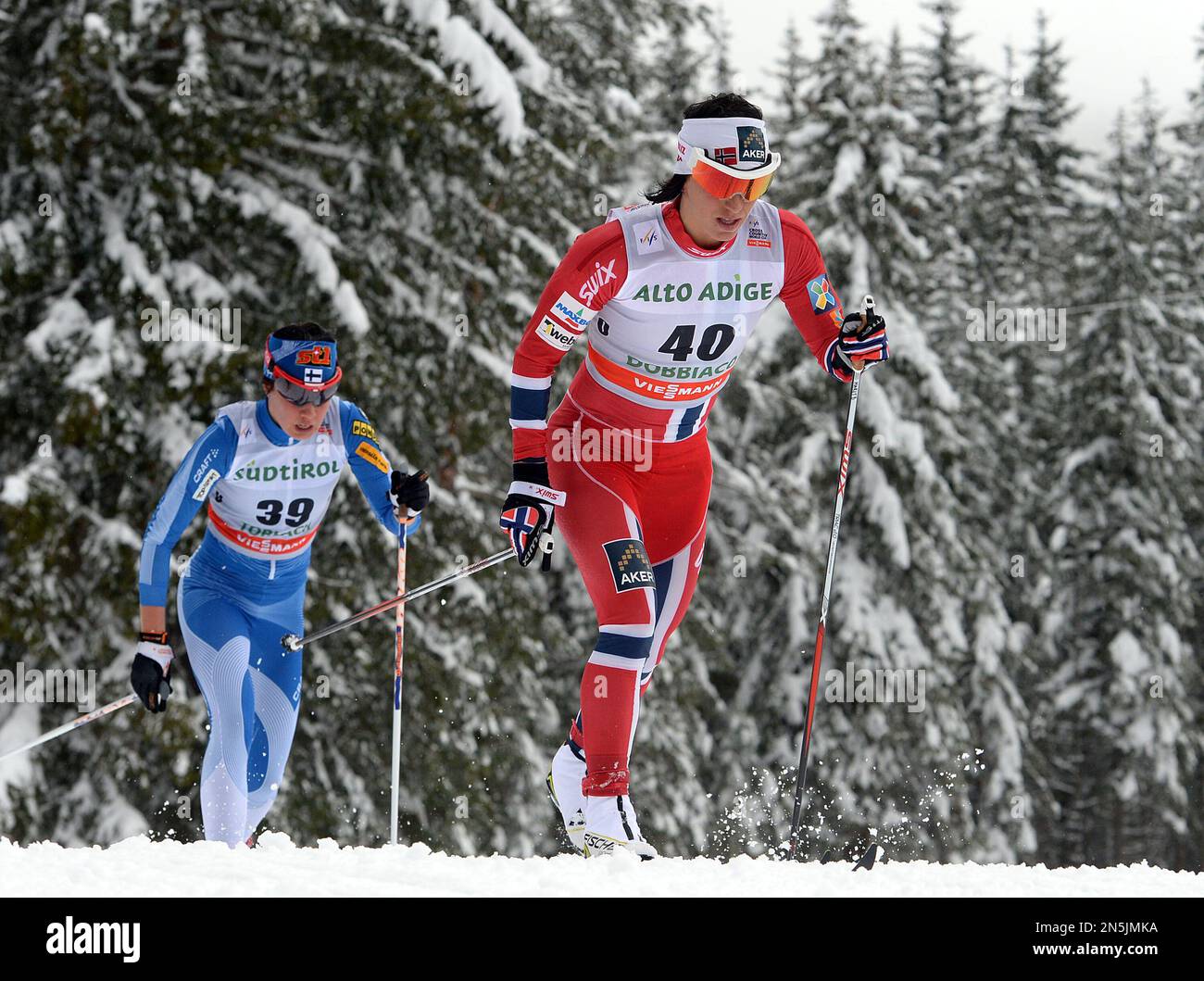 First placed Marit Bjoergen of Norway, right, skis followed by Kerttu ...