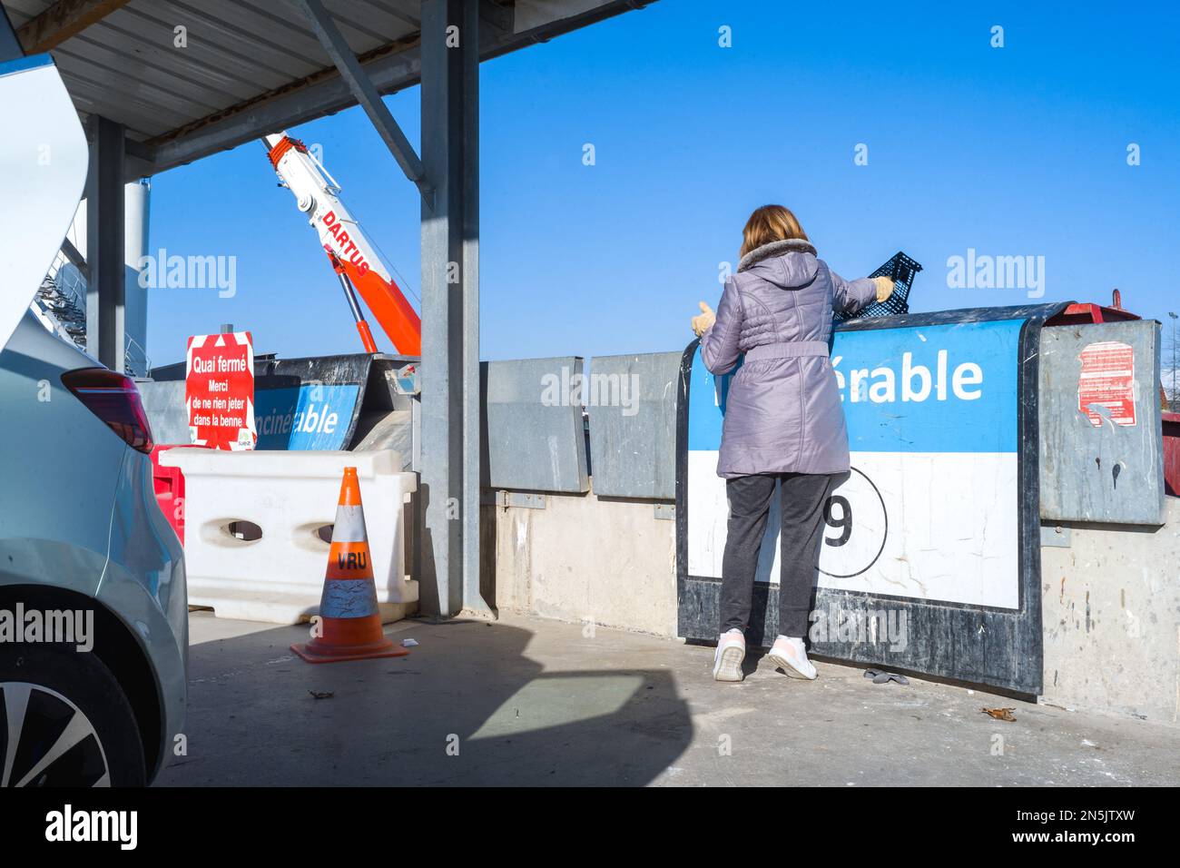 A woman from the back, throws these bulky things into compartment 9 ...