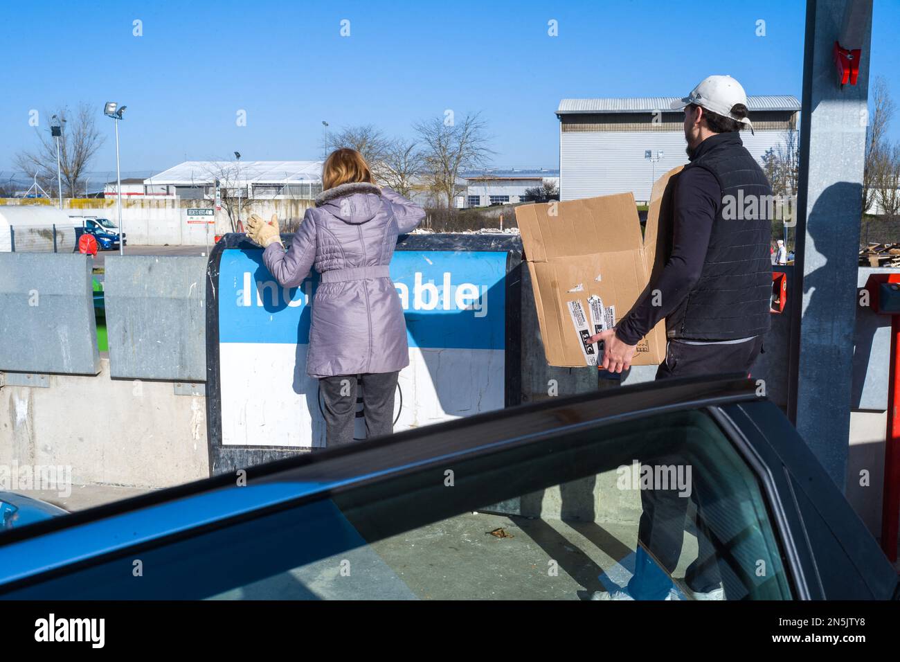 A woman from the back, throws these bulky things into compartment 9 ...