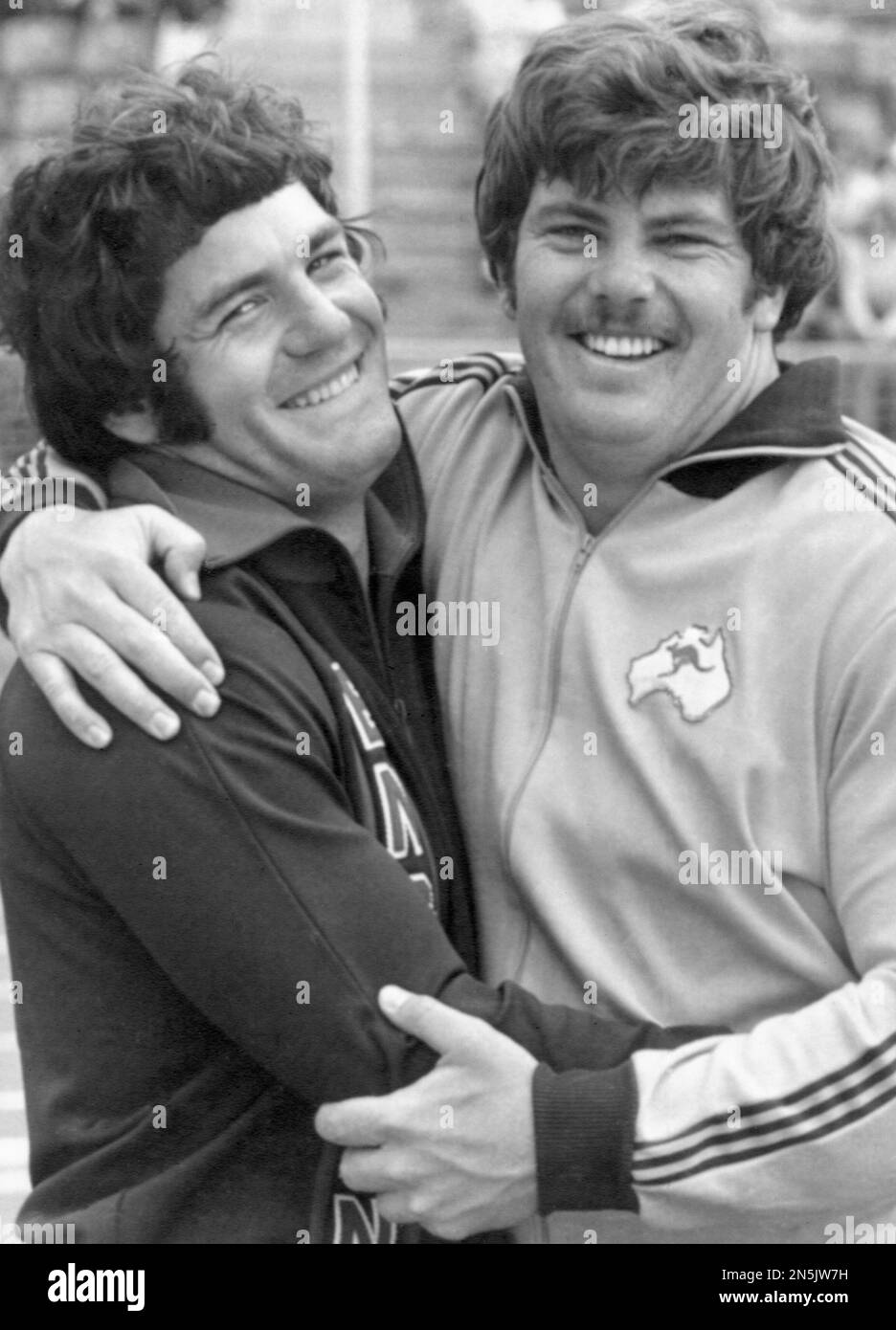 Hammer Throwing Gold medal winner Ian Chipchase of England, left, gets ...