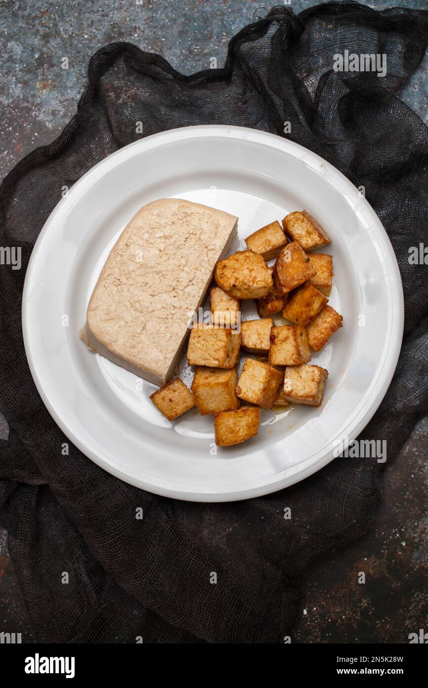 crispy deep stir fried tofu cubes on small white dish Stock Photo - Alamy