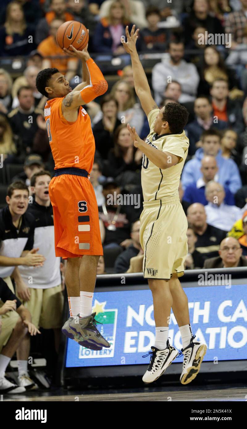 Syracuse's Michael Gbinije, left, shoots over Wake Forest's Miles ...