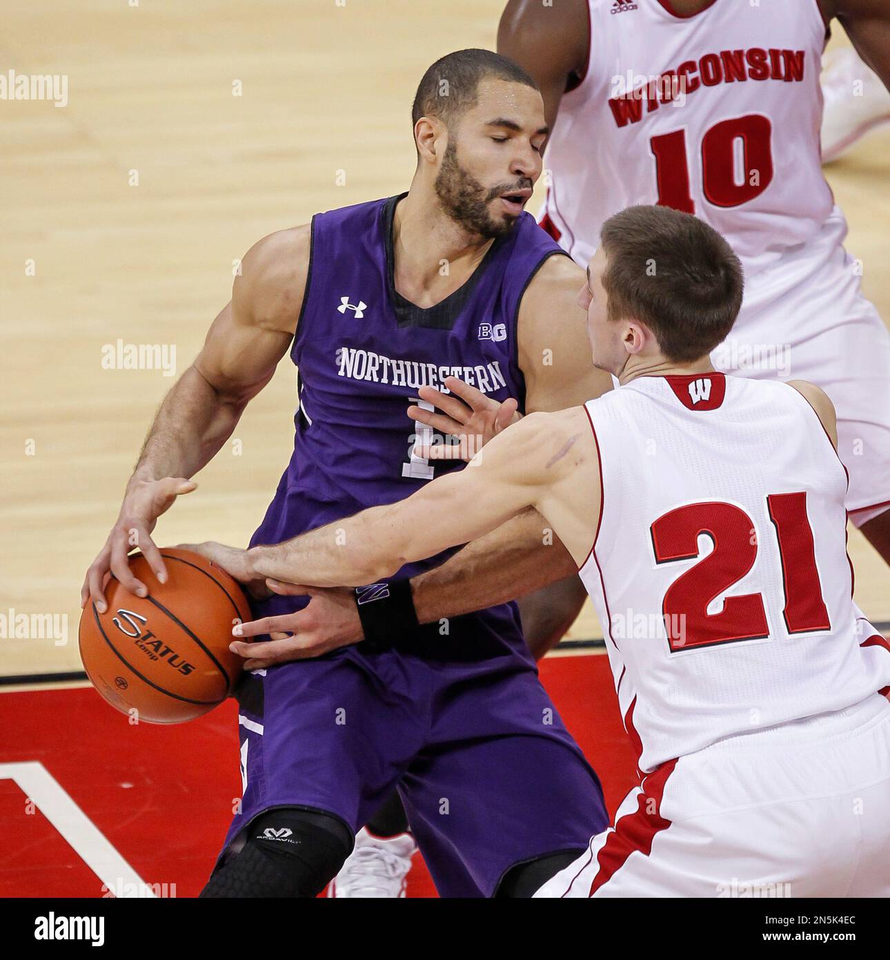 Wisconsin's Josh Gasser (21) knocks the ball loose from Northwestern's ...