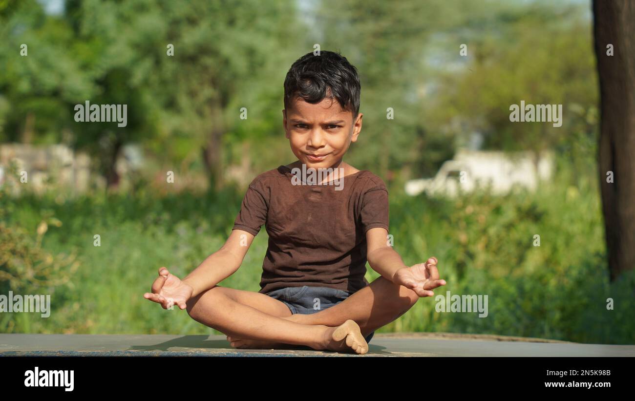 Little boy doing yoga in garden on beautiful nature background Stock ...