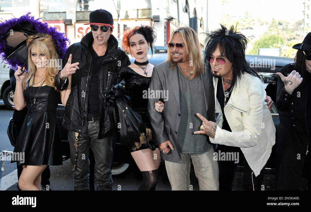 From left, Motley Crue band members, Tommy Lee, an unidentified woman ...