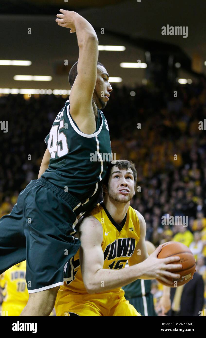 Iowa forward Zach McCabe, right, looks to shoot in front of Michigan ...