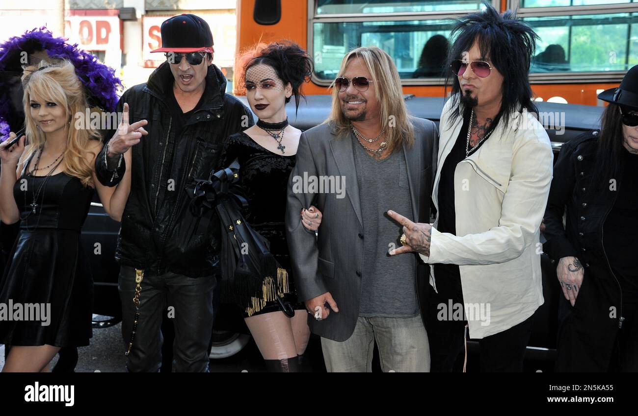 From left, Motley Crue band members, Tommy Lee, an unidentified woman ...