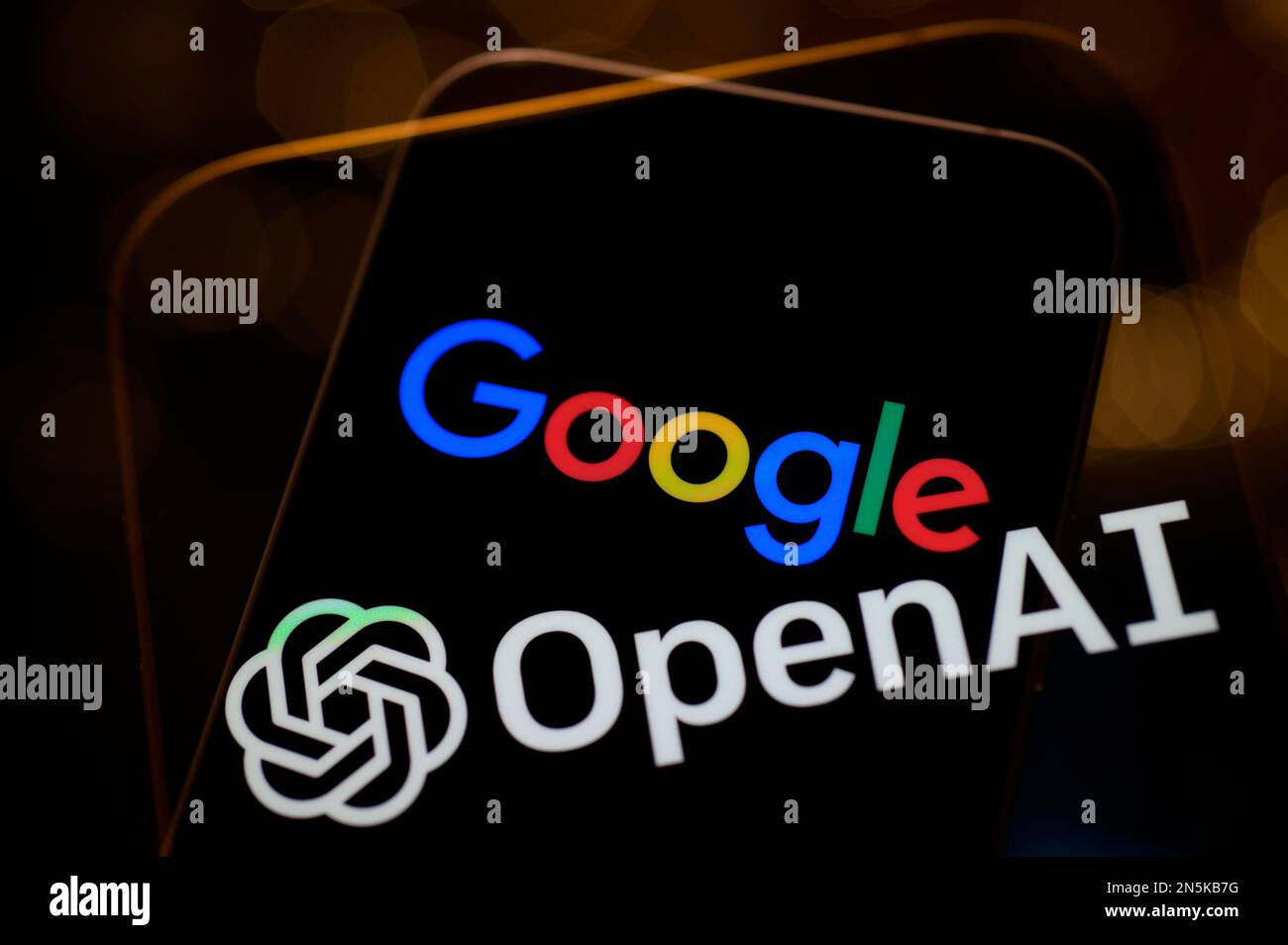 The OpenAI ChatGPT and Google logos are seen on mobile devices in this ...