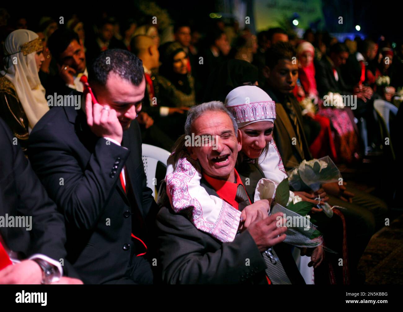 Palestinian couples are pictured, during a mass wedding ceremony, in ...