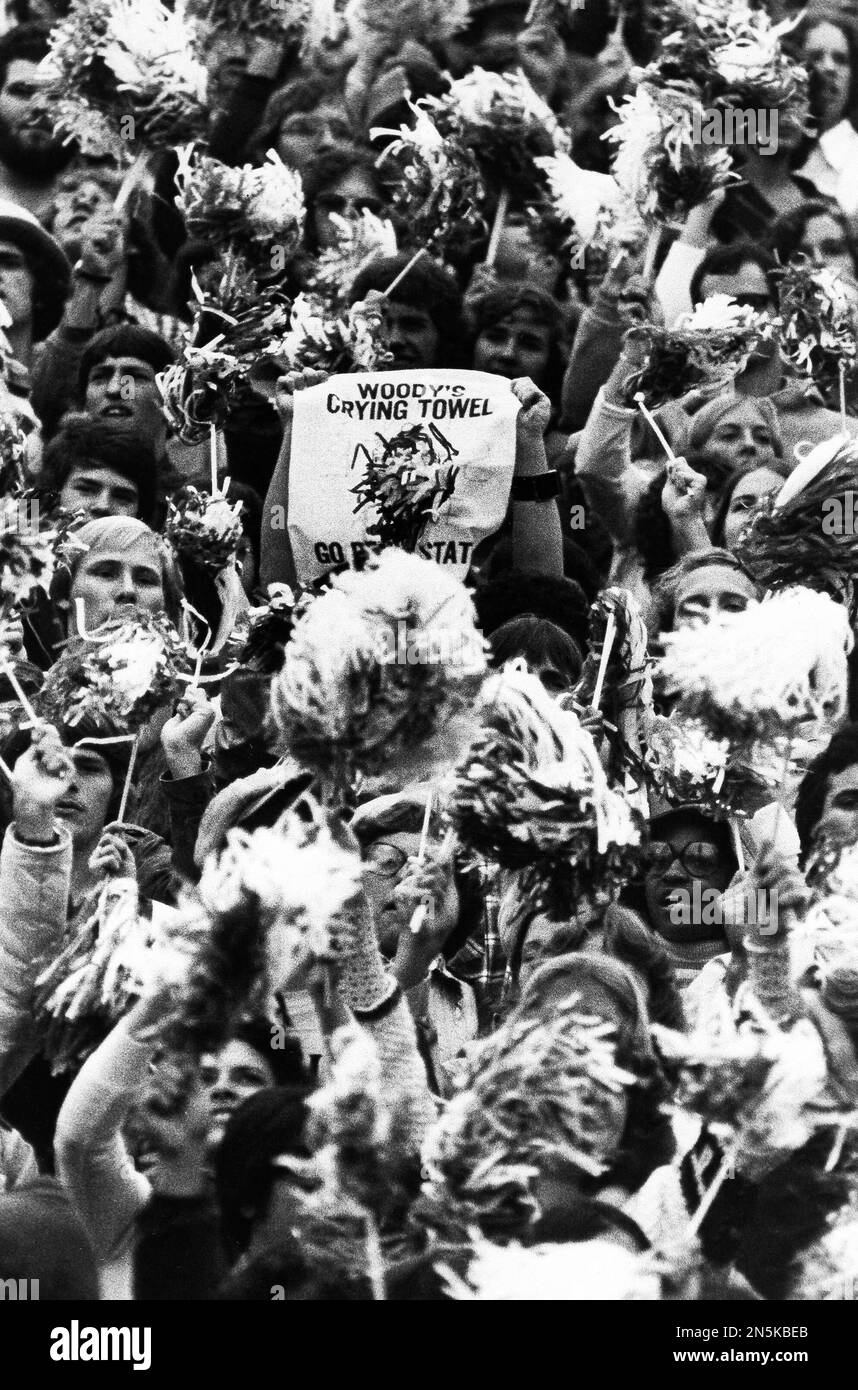A Penn State fan holds a "Woody's Crying Towel", surrounded by other ...