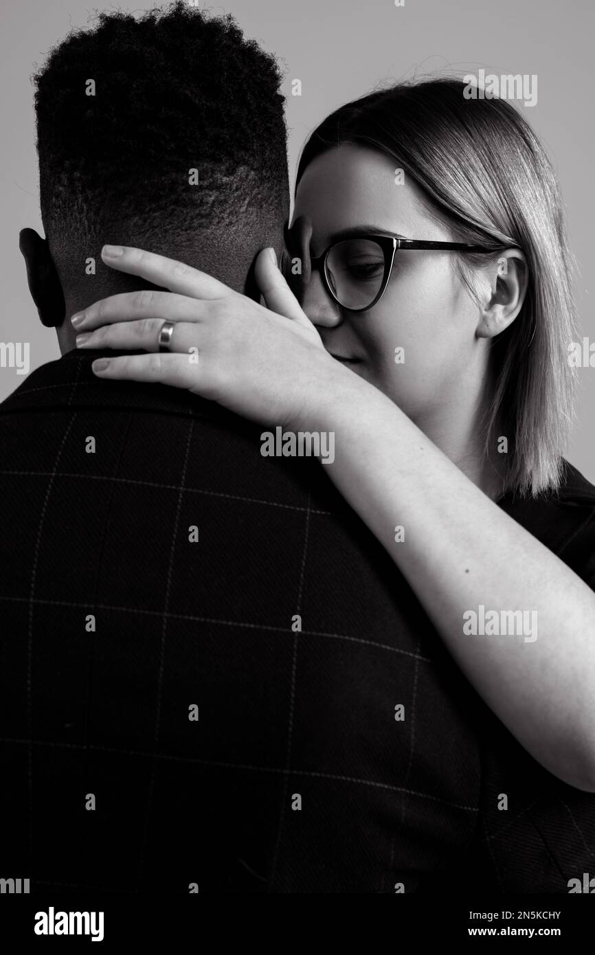 Young interracial couple is embracing. Portrait. Black and white image ...