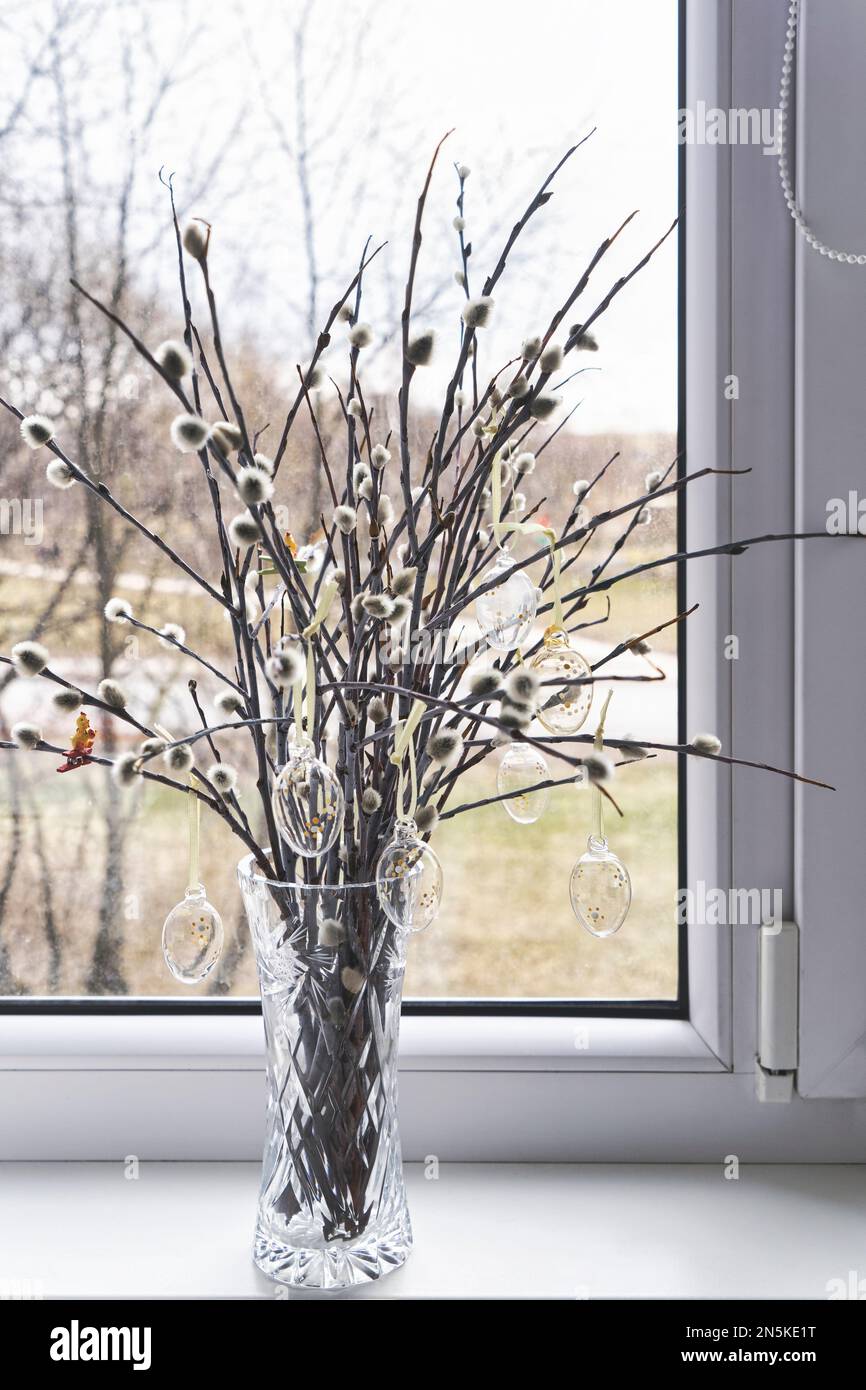 Crystal vase on windowsill with bunch of willow sprigs decorated for ...
