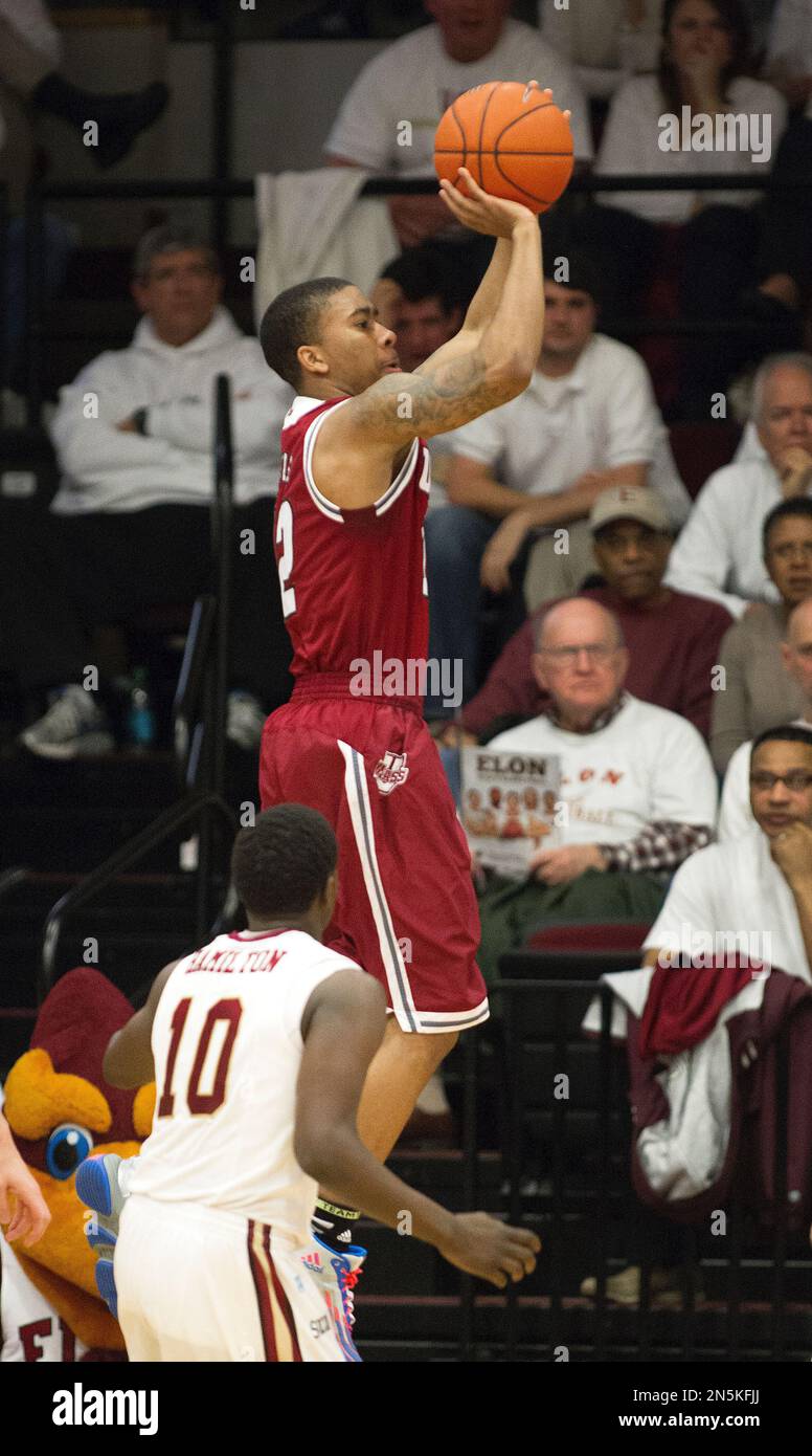 Massachusetts guard Trey Davis (12) shoots with Elon guard Austin ...