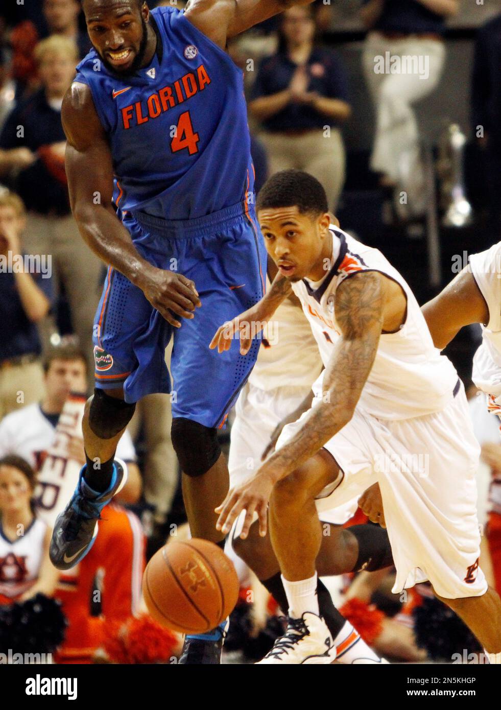 Florida center Patric Young (4) tries to defend as Auburn guard Chris ...