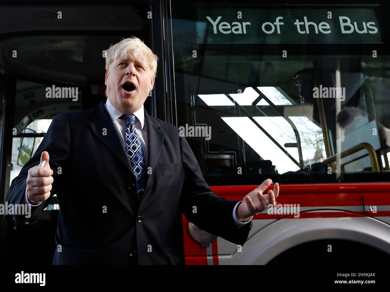 Boris Johnson the Mayor of London stands in front of a routemaster bus ...