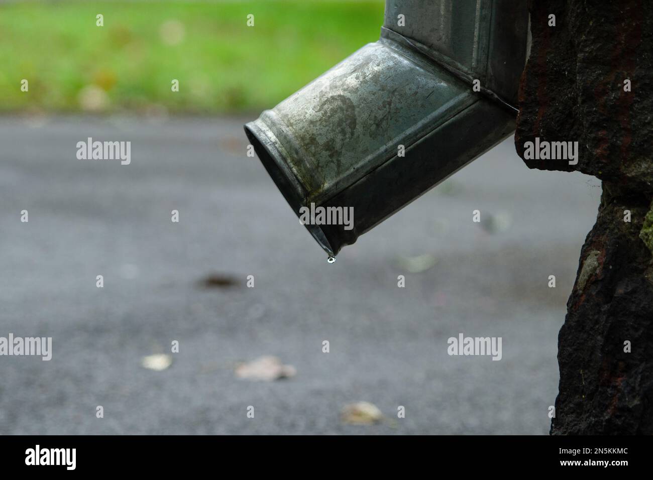 Gutter Downspout with drop of water, side view Stock Photo - Alamy
